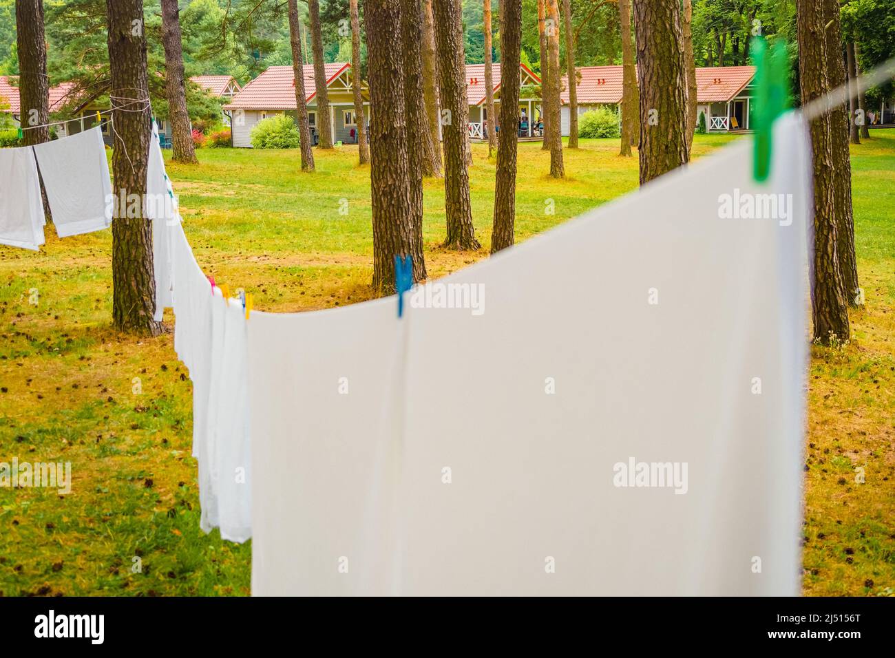 close up photo of fresh white laundry hanging on a washing rope with ...