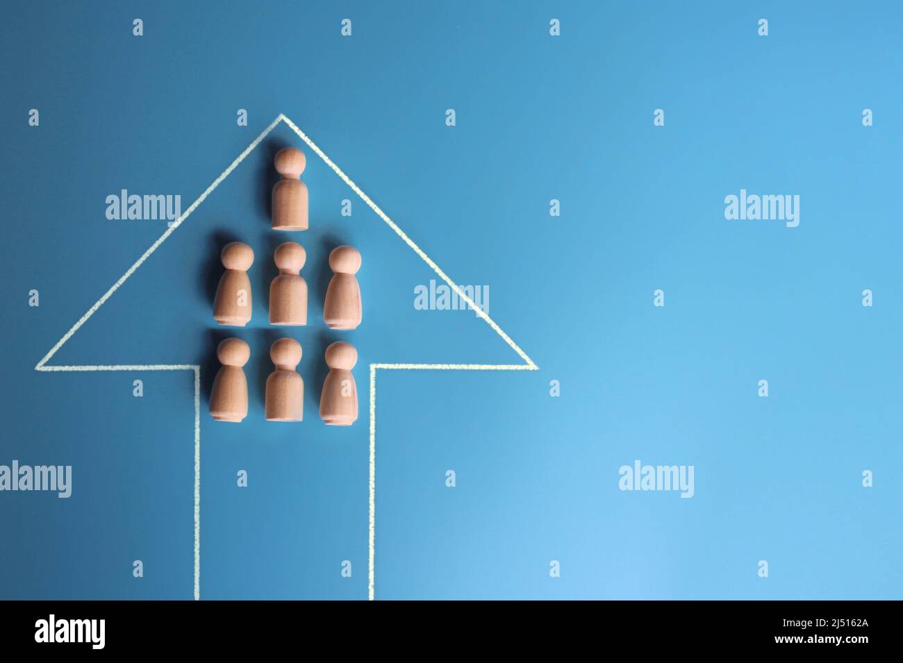 Wooden dolls and arrow. Consolidation, same goal, organization ...