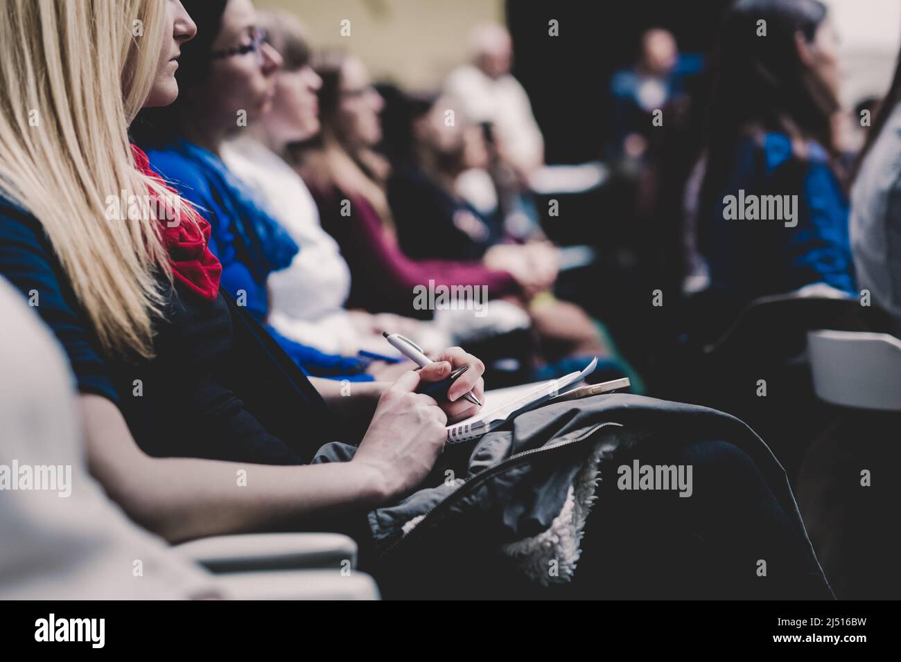 Hands holding pens and making notes at conference lecture Stock Photo ...