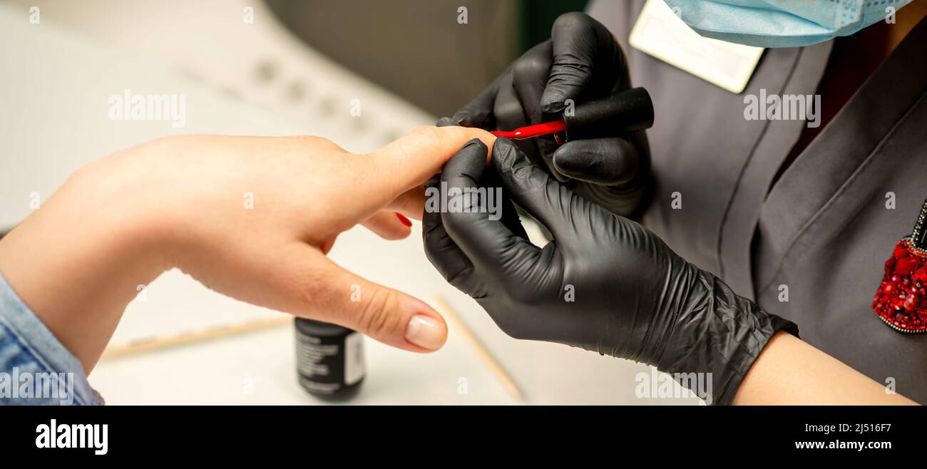 Black woman applying nail paint hi-res stock photography and images - Alamy