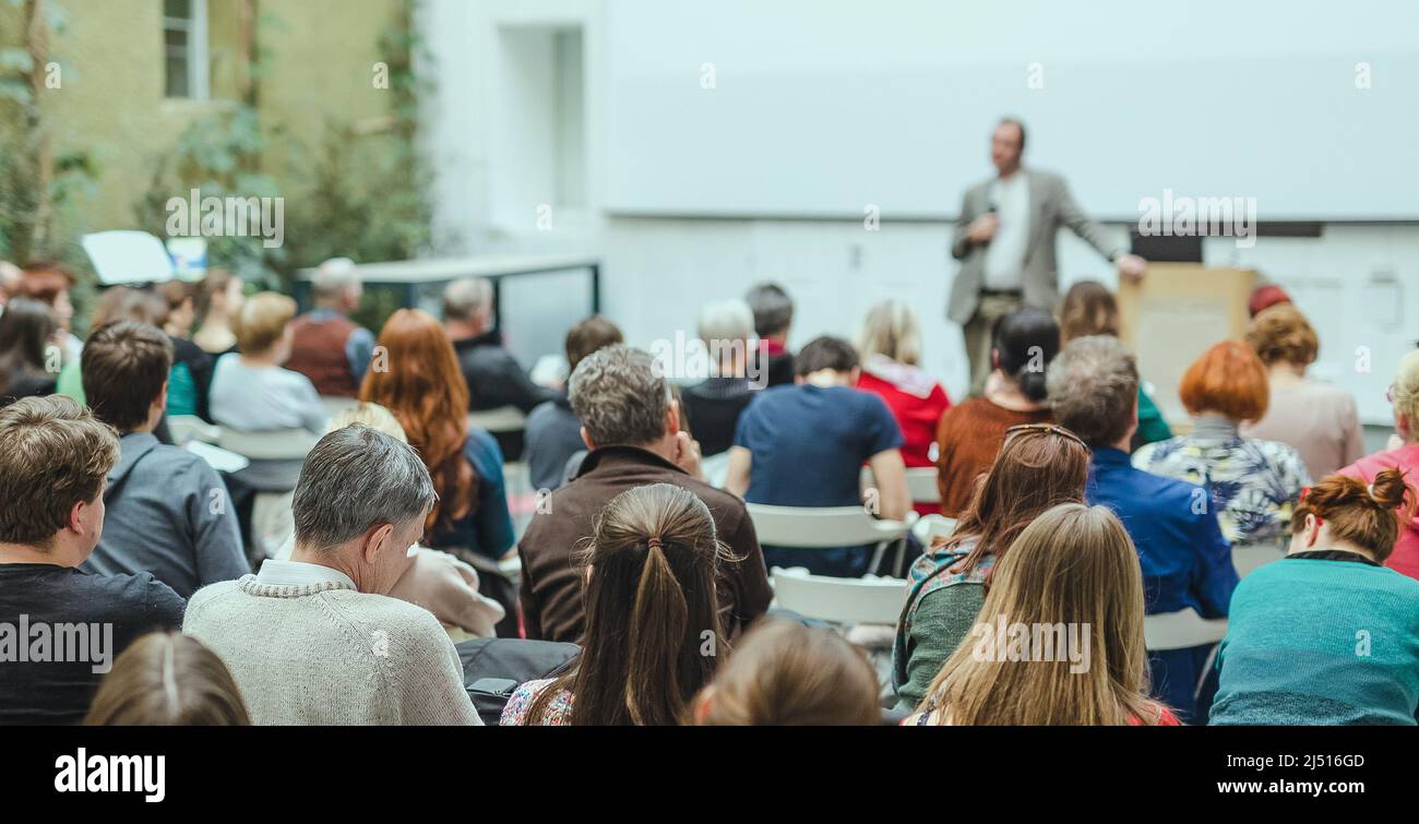 Man giving presentation in lecture hall at university Stock Photo - Alamy