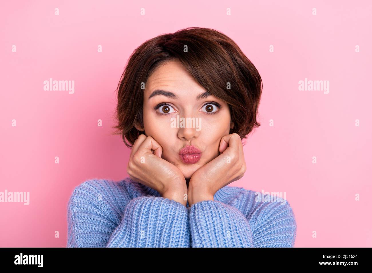 Photo of cute kind person kiss lips hands cheeks look camera isolated ...