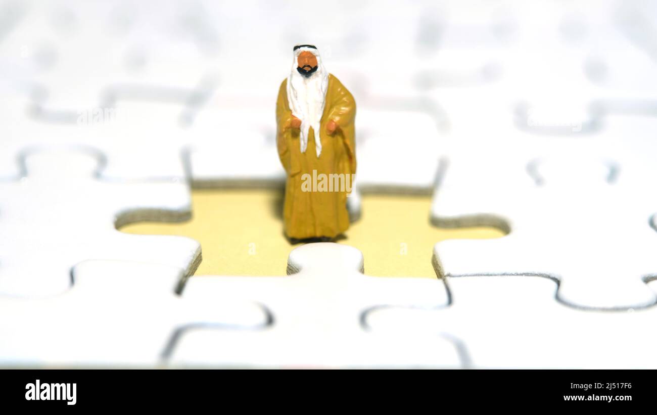 Miniature people toy figure photography. A Sultan wearing yellow Bisht ...