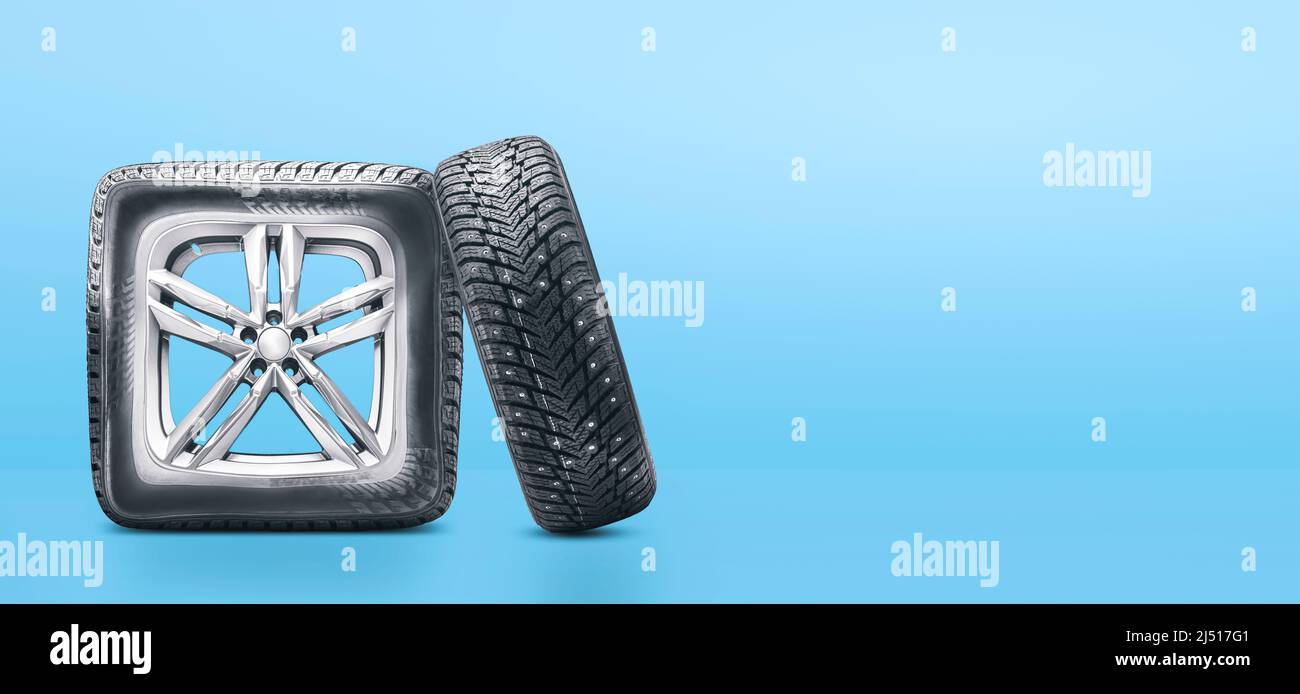 The new funny fake tire is square, damaged or repaired on a summer blue ...