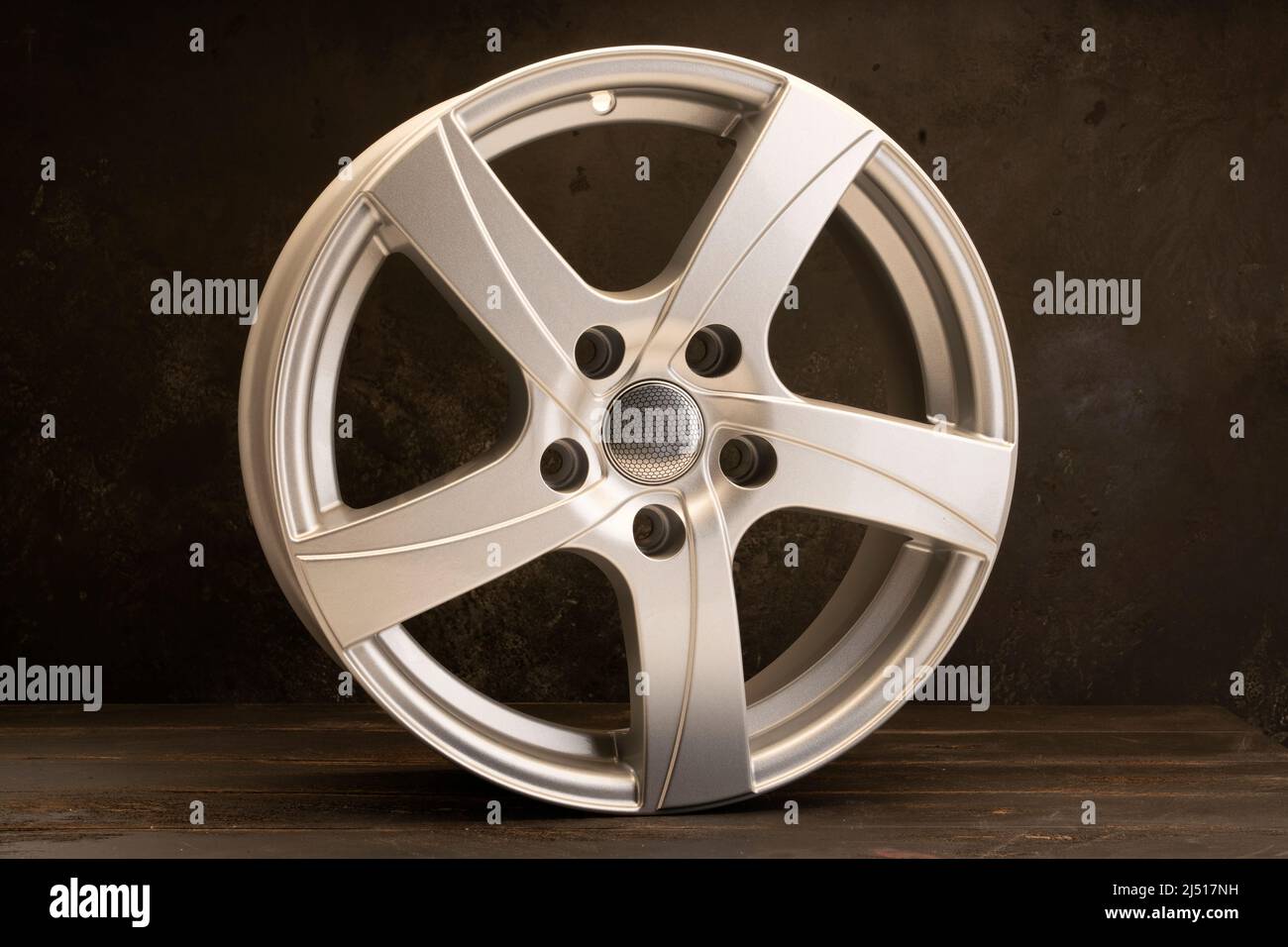 new grey alloy wheels on a dark textured black background. a wheel for ...
