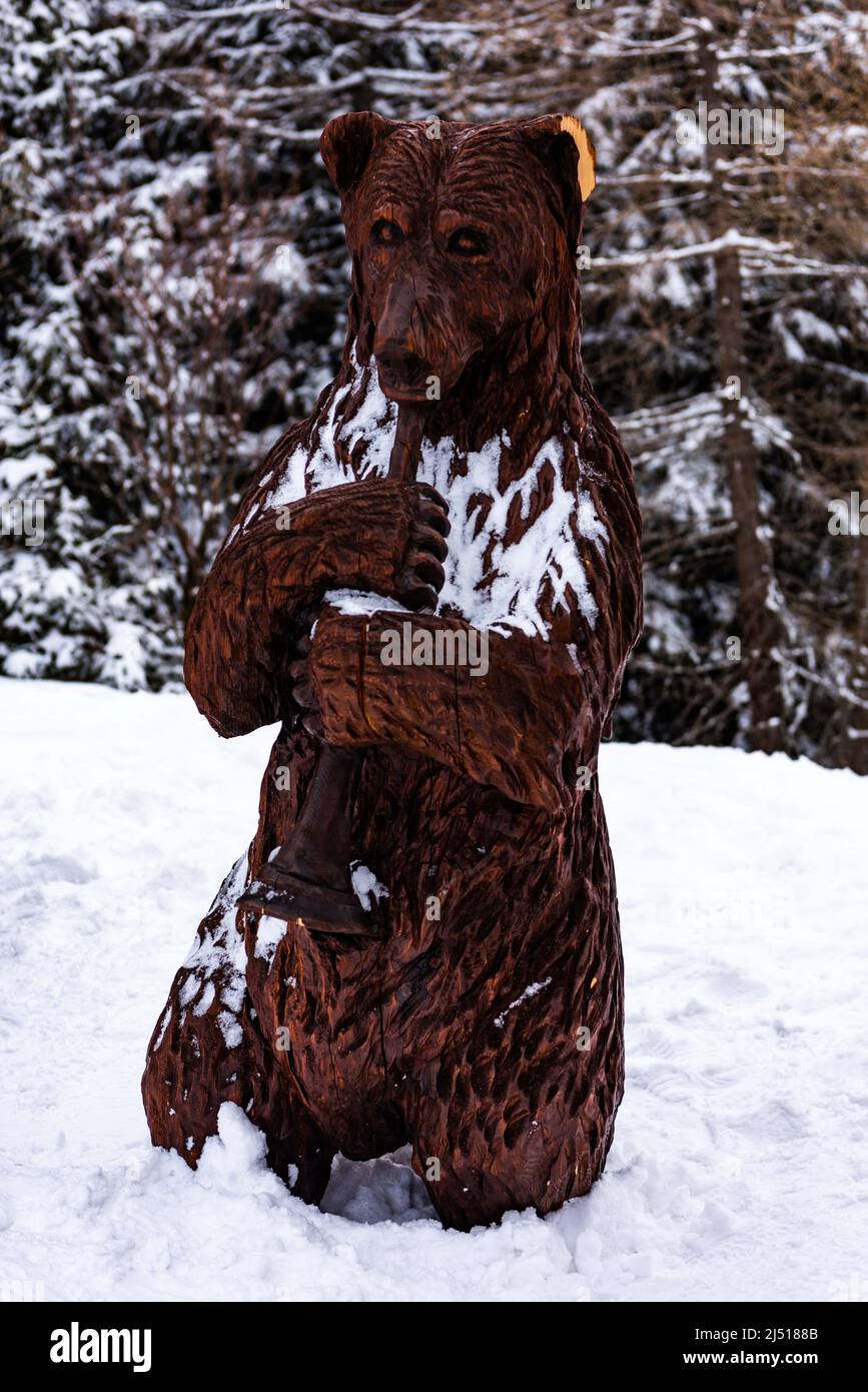 Wooden bear in winter playing musical instrument Stock Photo - Alamy