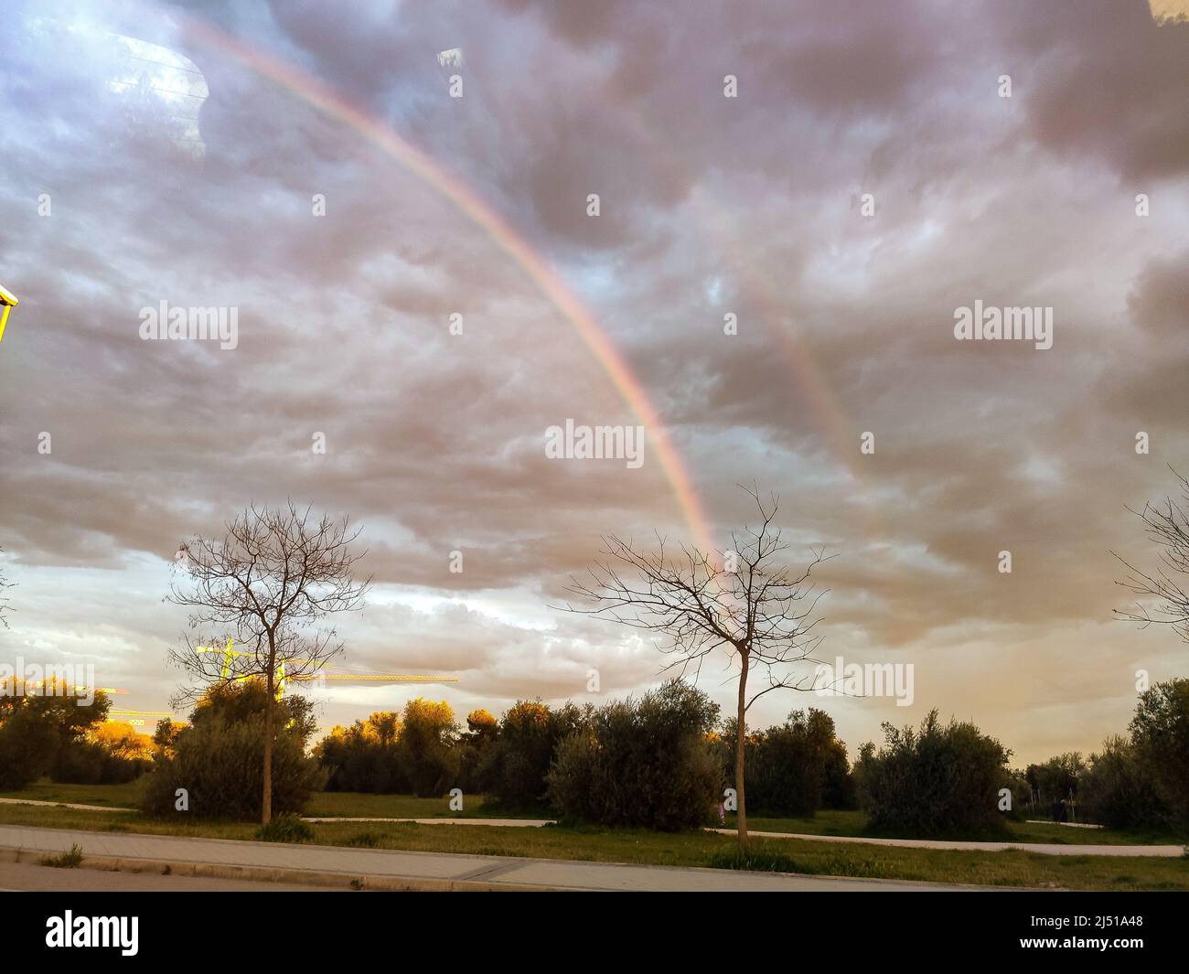 Rainbow. Colorful rainbow in the sky of Valdemoro at sunset, coinciding ...