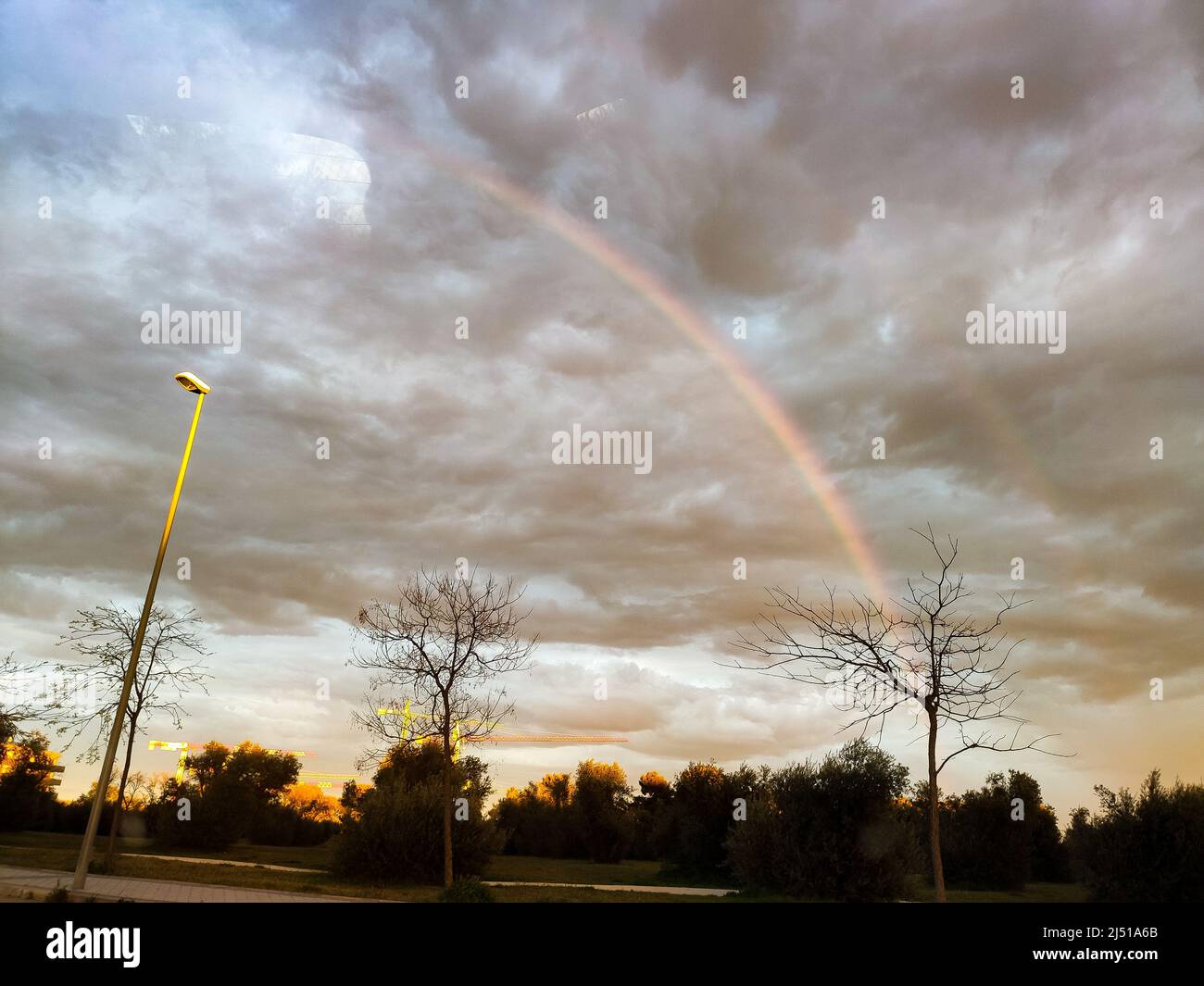 Rainbow. Colorful rainbow in the sky of Valdemoro at sunset, coinciding ...