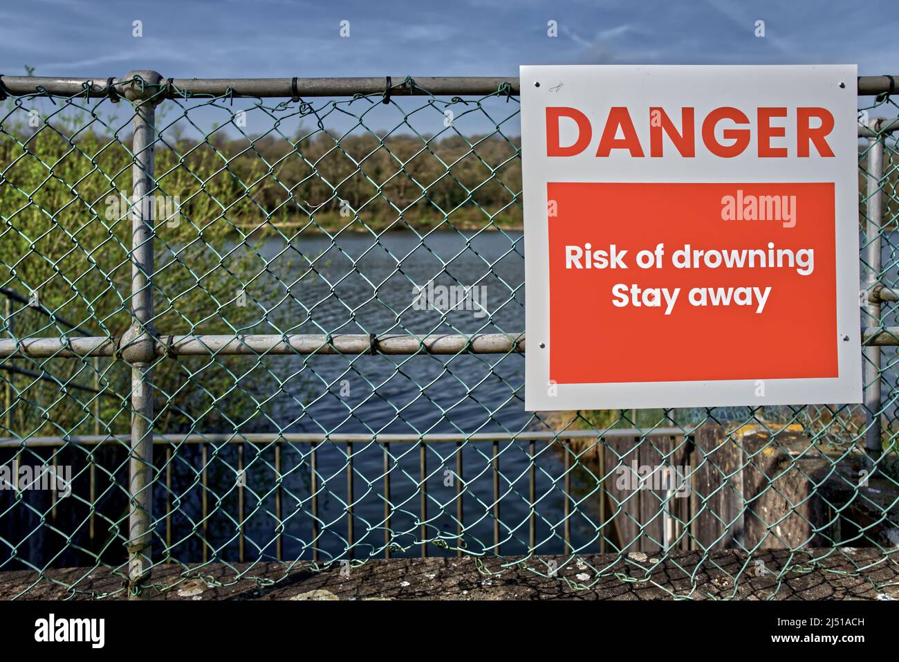 Danger risk of drowning signs alongside open deep water for safety ...