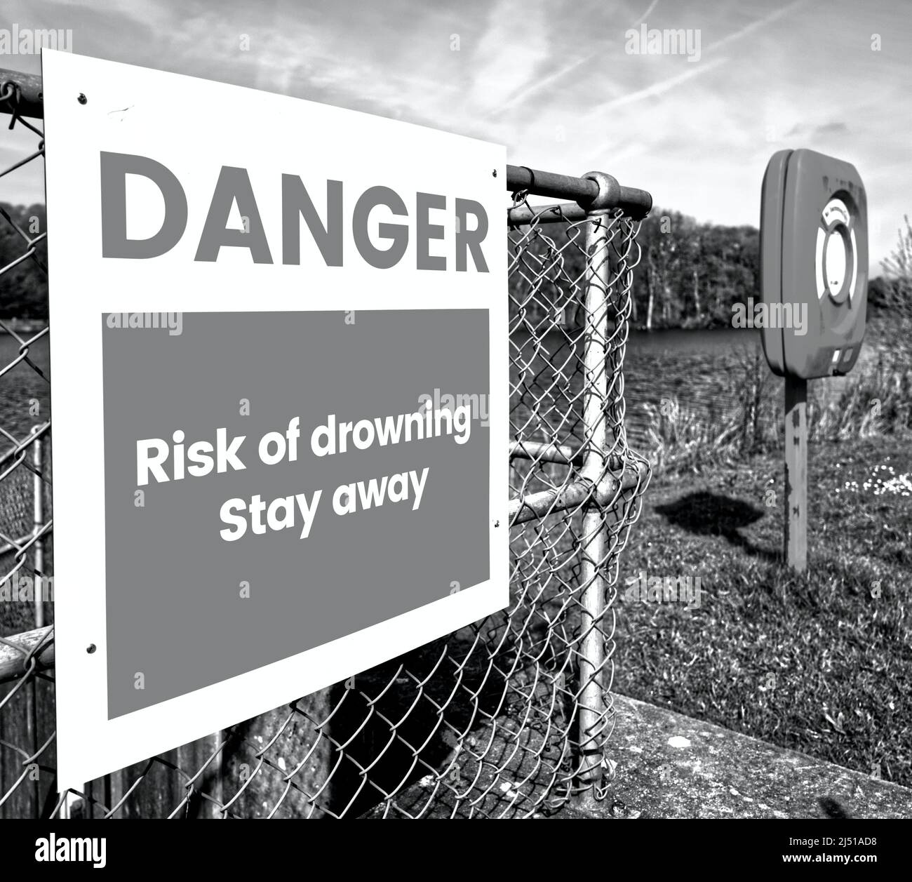 Danger risk of drowning signs alongside open deep water for safety ...