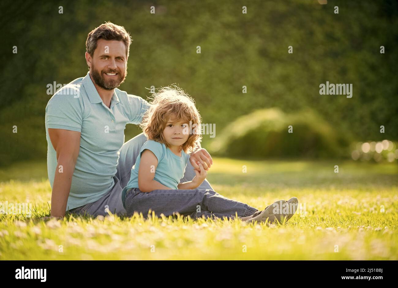 happy family portrait of father and son boy relax in summer park green ...