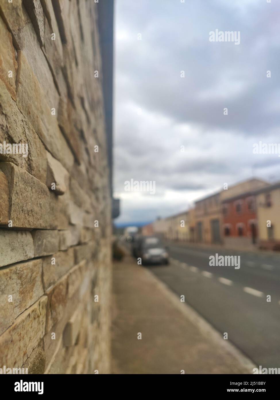 Wall. Photograph of an exterior brick wall in various shades of brown ...