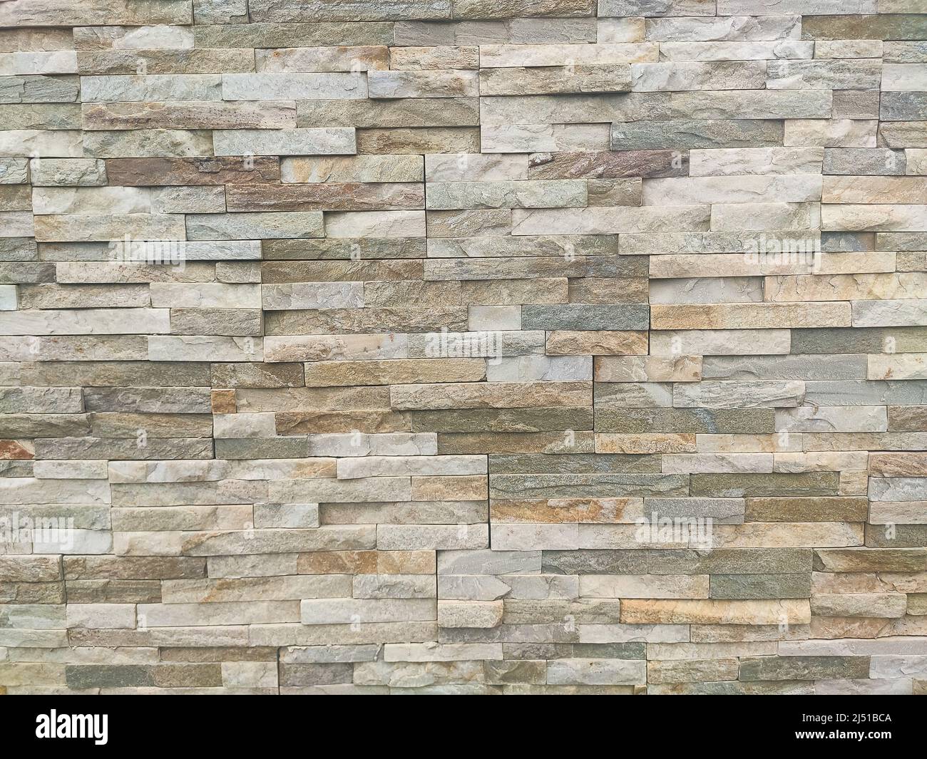 Wall. Photograph of an exterior brick wall in various shades of brown ...