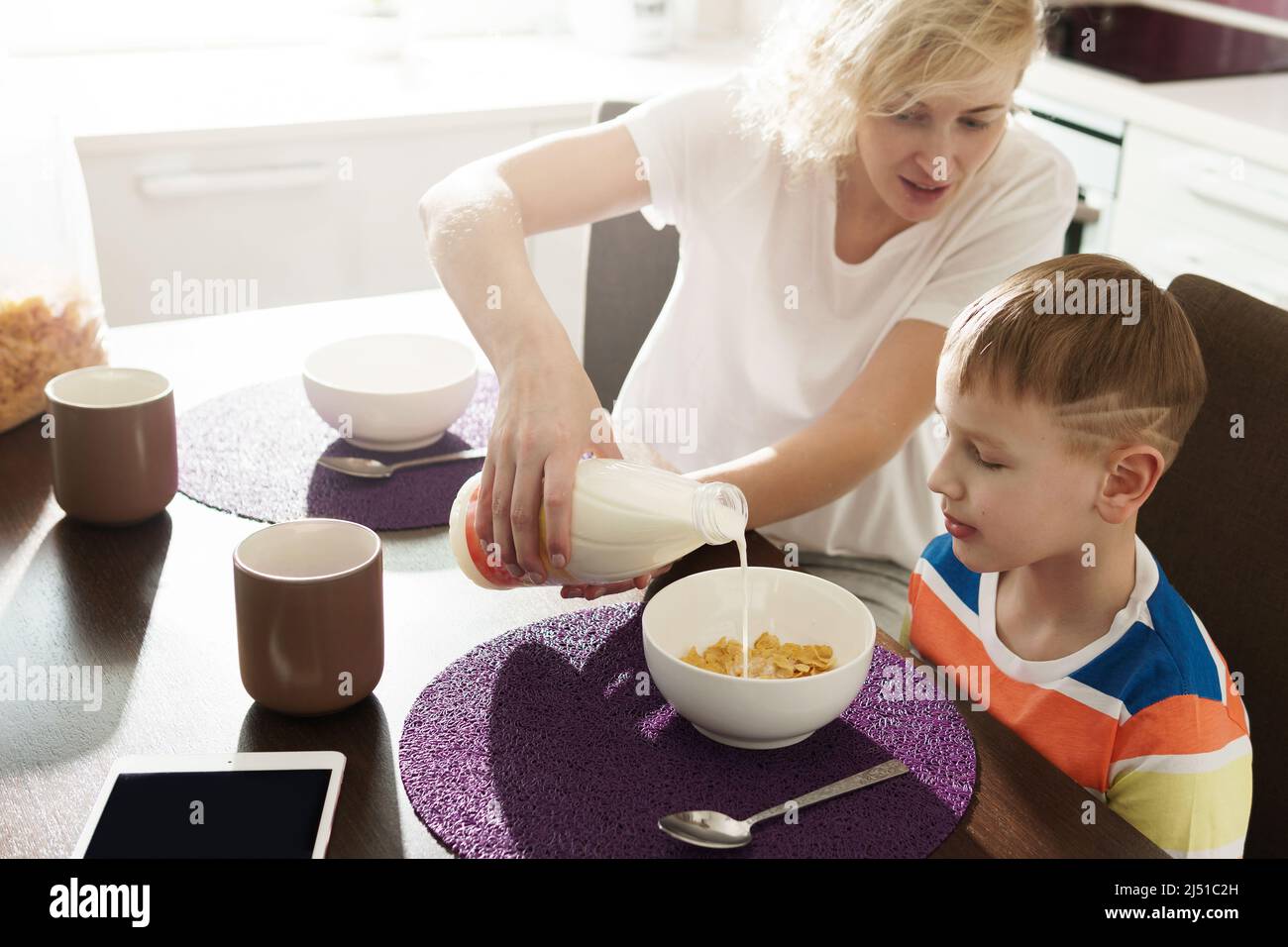 Boy pouring cornflakes hi-res stock photography and images - Alamy