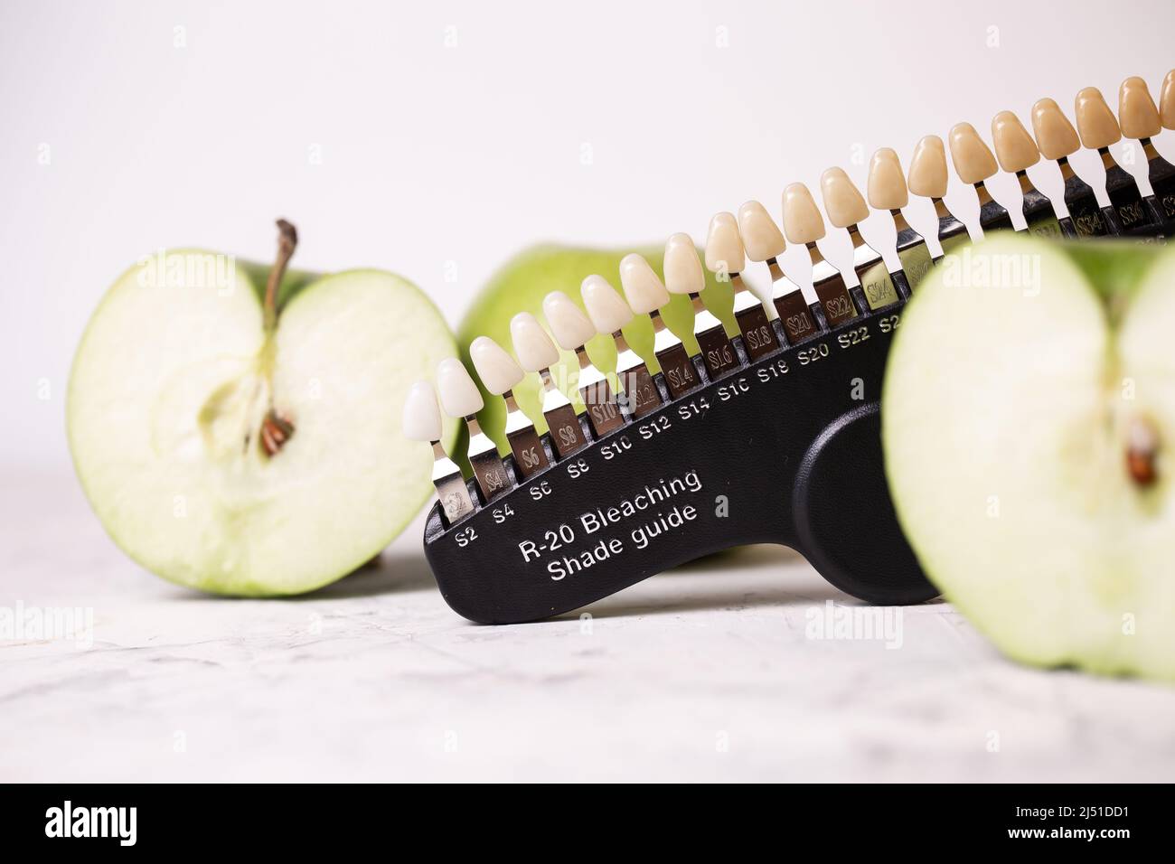 Color scale of teeth cosmetic dentistry. Scale and green apples Stock ...