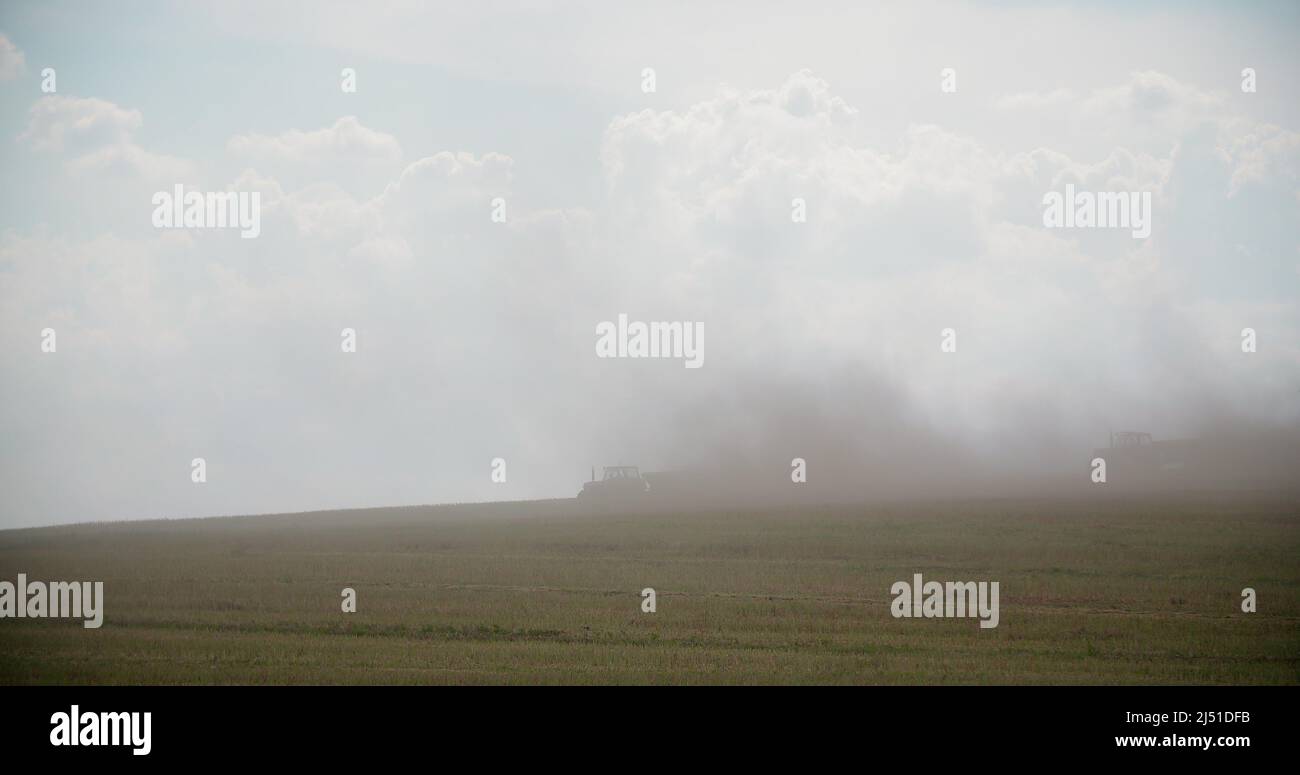 Tractors Blowing Dust On Field Stock Photo - Alamy