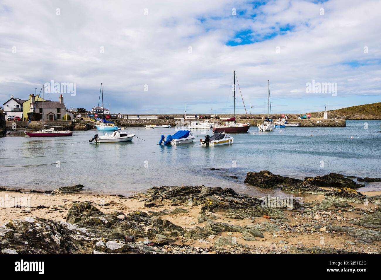 Boats moored in Cemaes harbour at high tide on the north coast. Cemaes ...