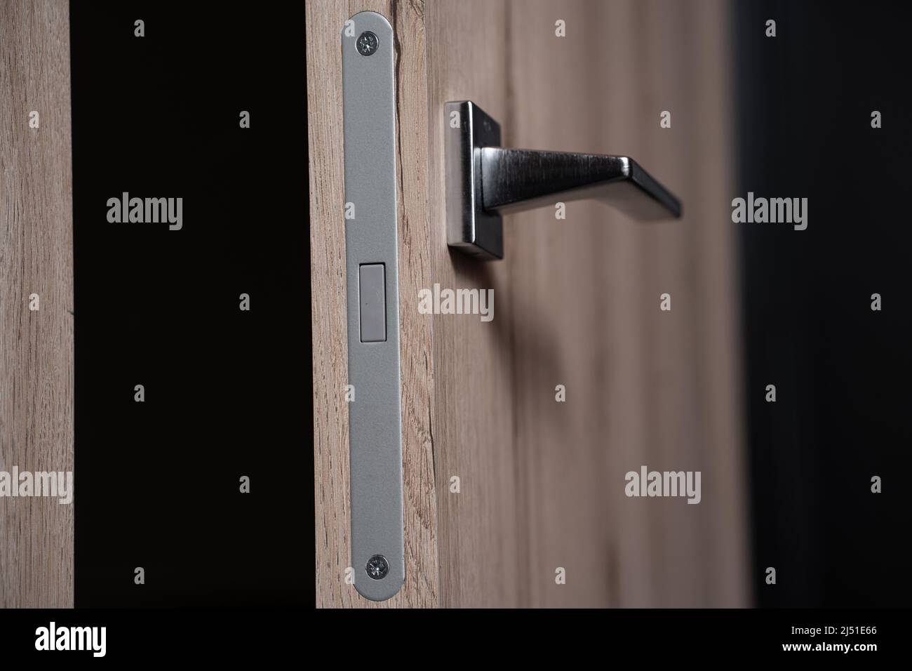 modern and secured metal door handle and latch detail Stock Photo - Alamy
