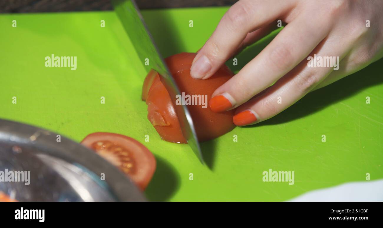 slicing tomato in kitchen Stock Photo - Alamy
