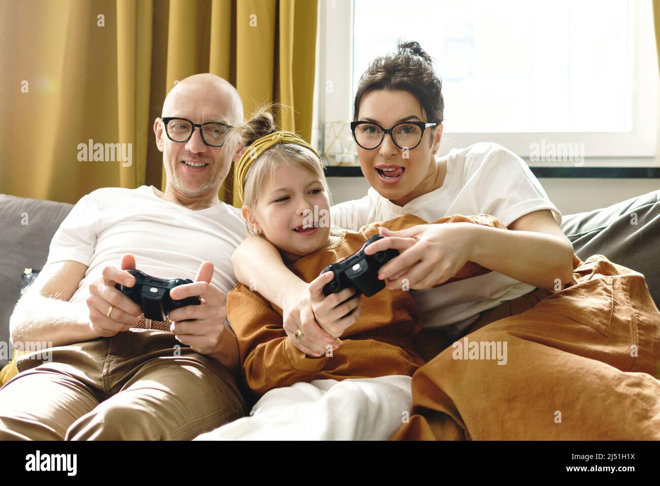 Young and happy family is playing video game console at home Stock ...