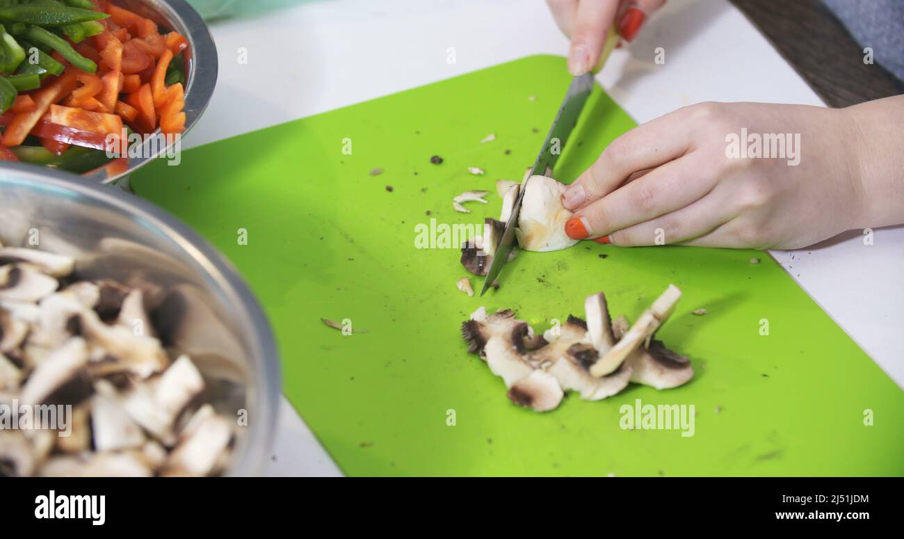 Woman Hand cutting mushrooms fungi Stock Photo - Alamy