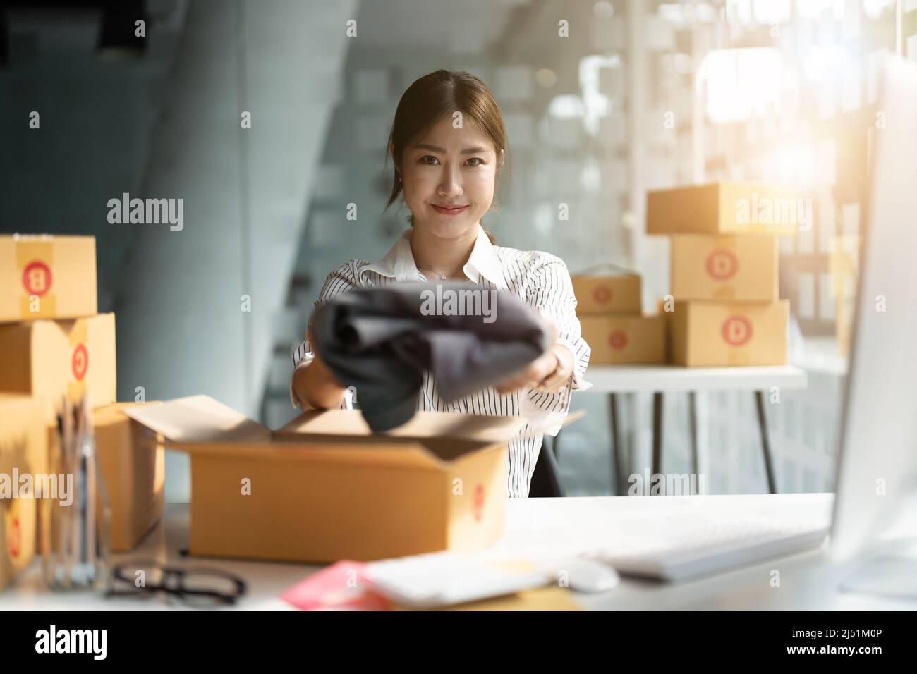 Young Asian small business owner working at home office, taking note on ...