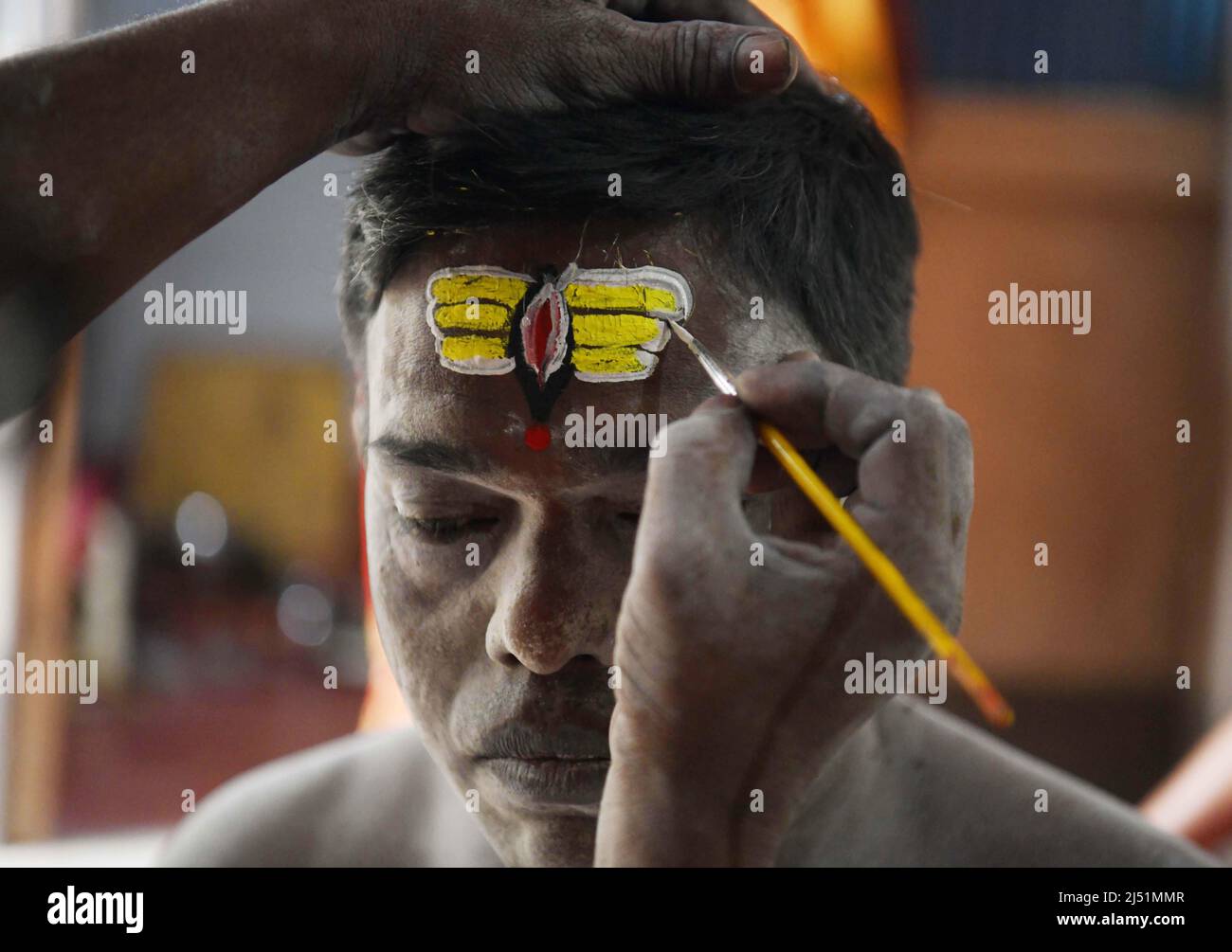 Folk artists are getting their makeup done to perform at the rituals of ...