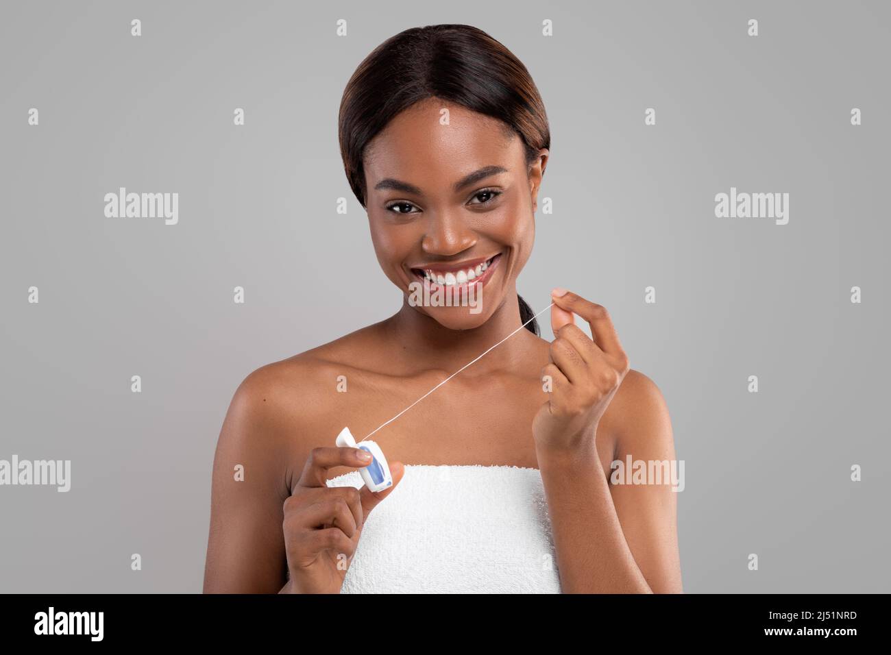 Smiling pretty young african american female wrapped in towel with ... Smiling pretty young african american female wrapped in towel with ...