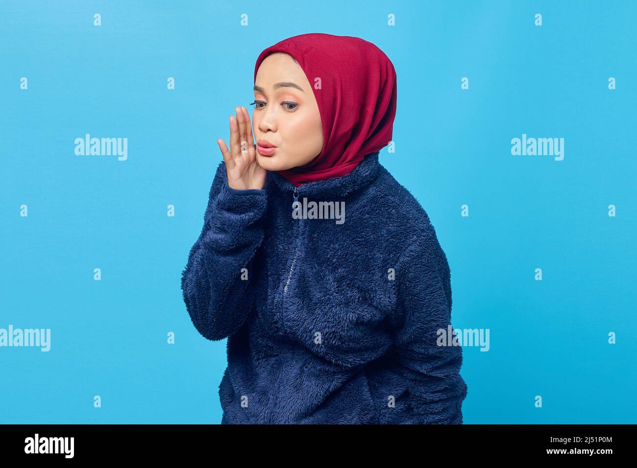 Portrait of beautiful Asian woman keeps hand near mouth and whisper ...