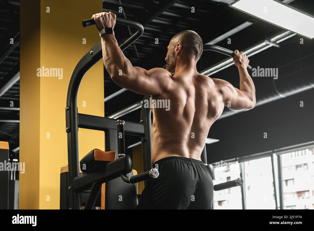 Muscular bodybuilder doing pull-ups during his workout in the gym Stock ...