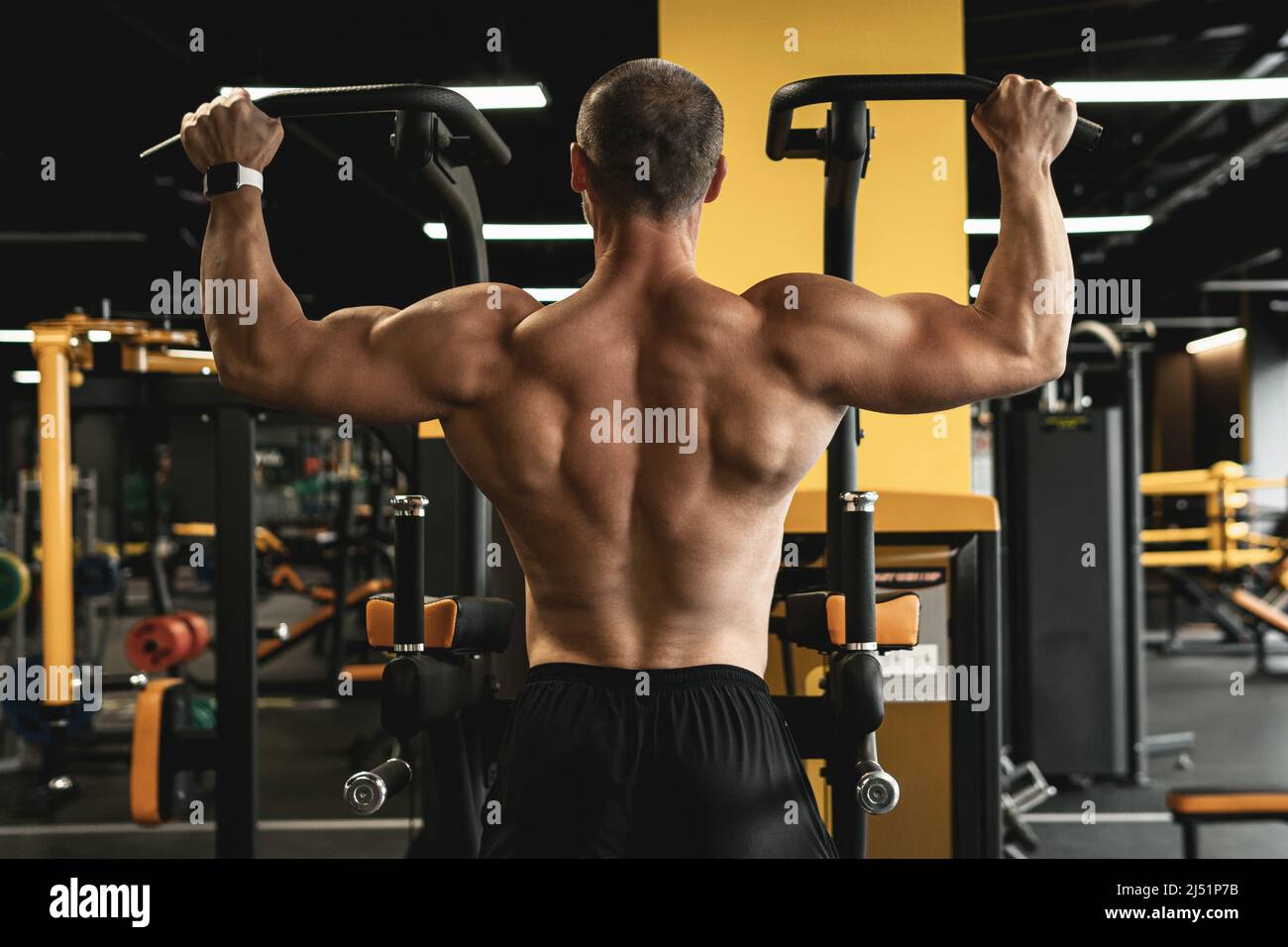 Muscular bodybuilder doing pull-ups during his workout in the gym Stock ...