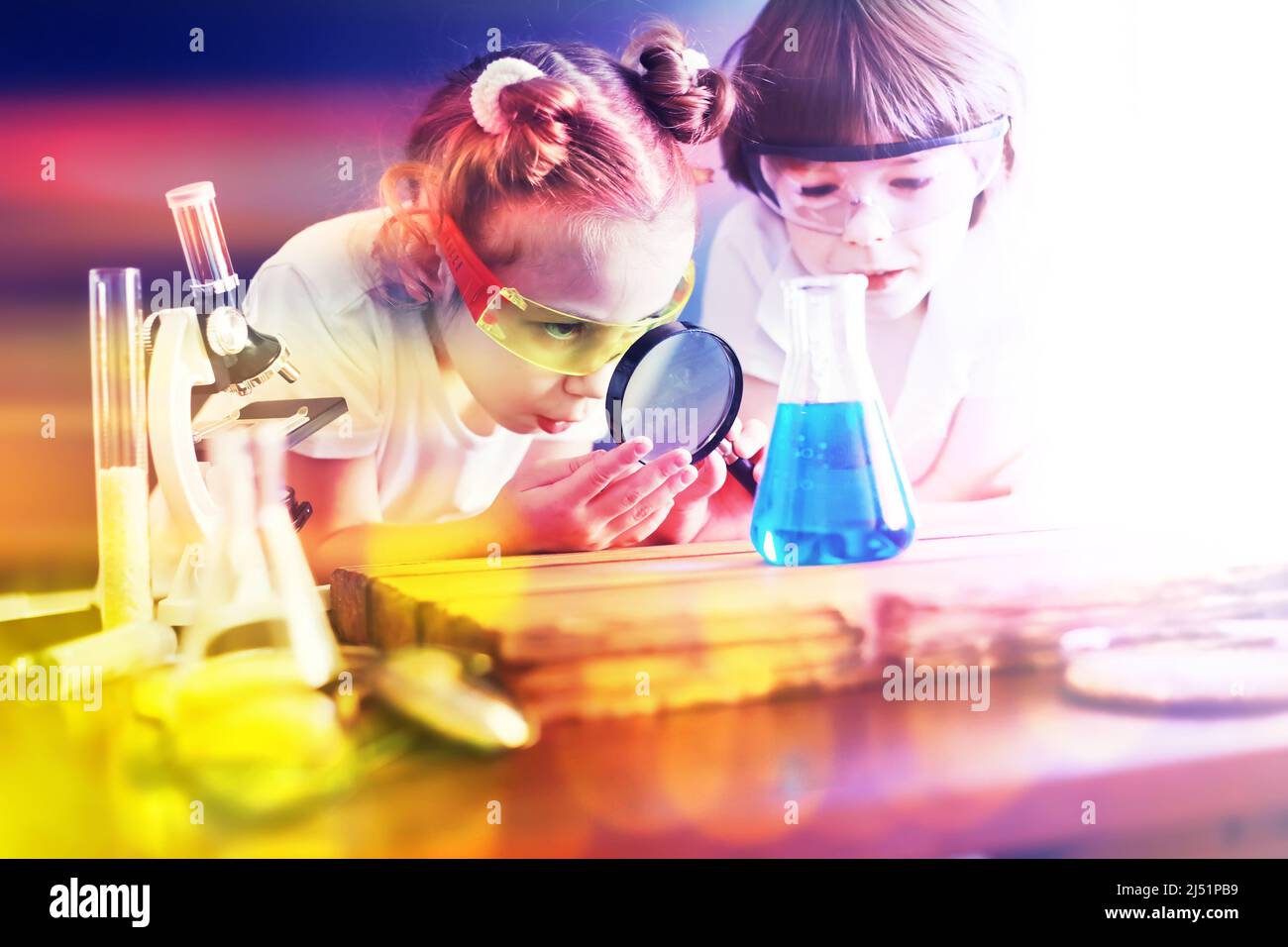Children scientists. Schoolchildren in laboratory conduct experiments ...