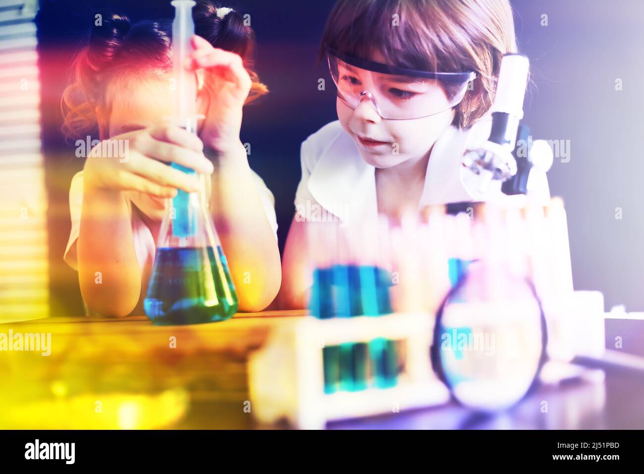 Children scientists. Schoolchildren in laboratory conduct experiments ...