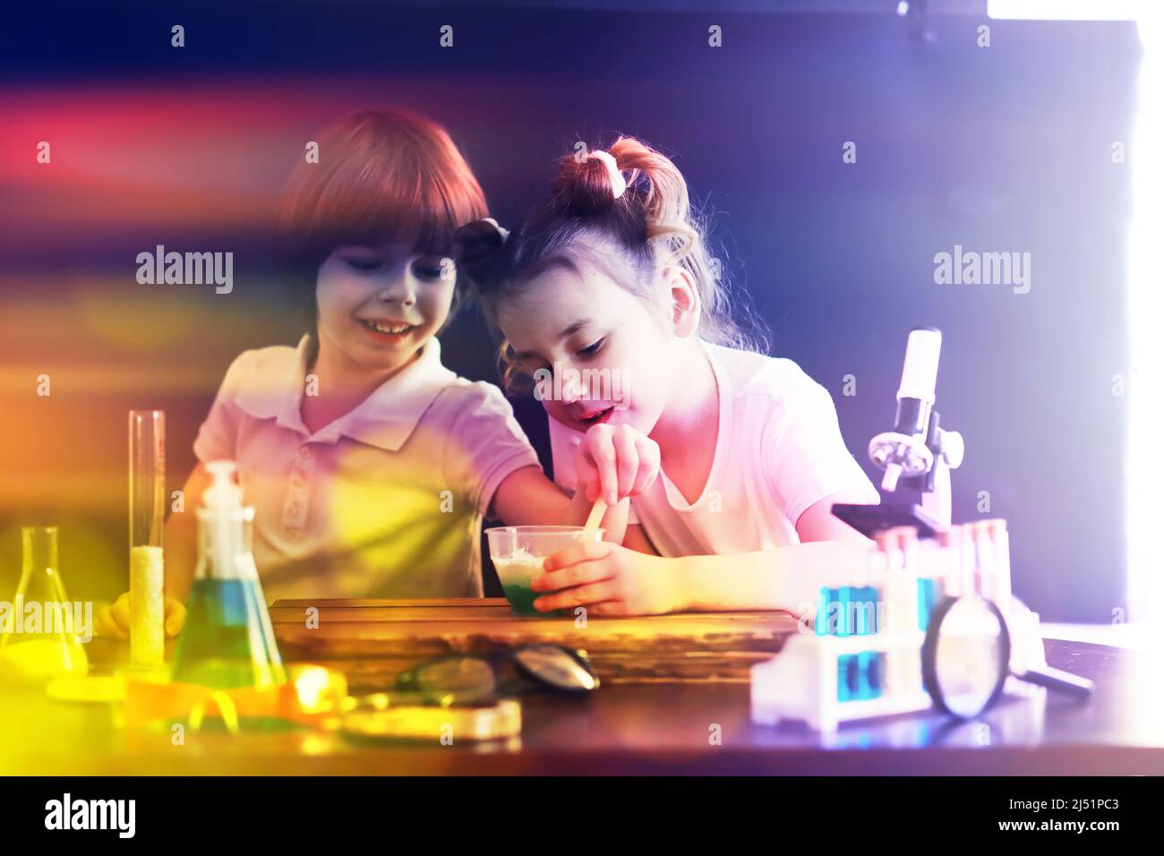 Children scientists. Schoolchildren in laboratory conduct experiments ...