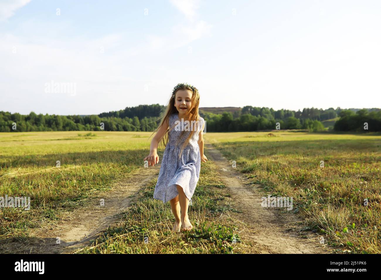 Children walk in the summer in nature. Child on a sunny spring morning ...