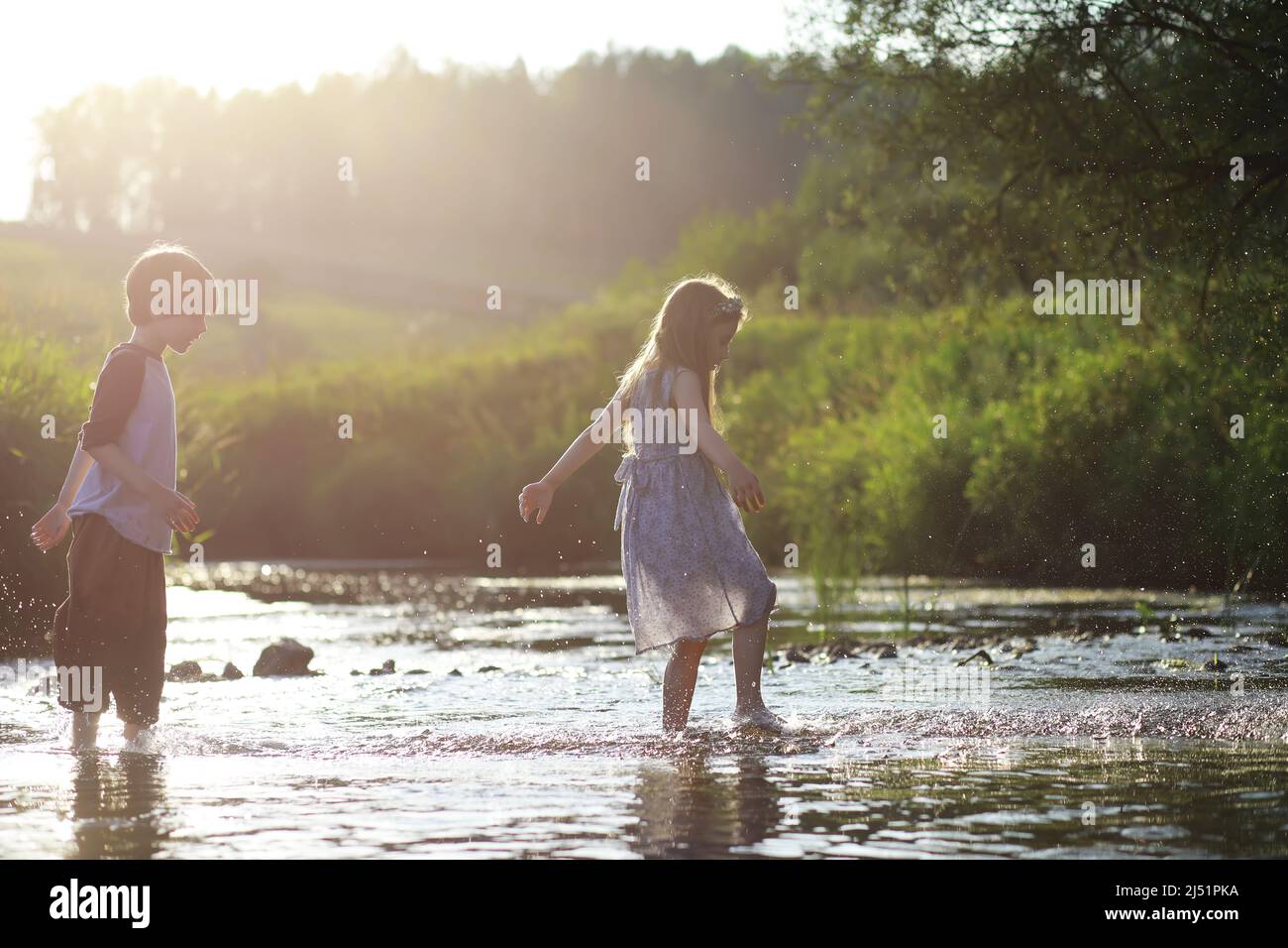 Children walk in the summer in nature. Child on a sunny spring morning ...
