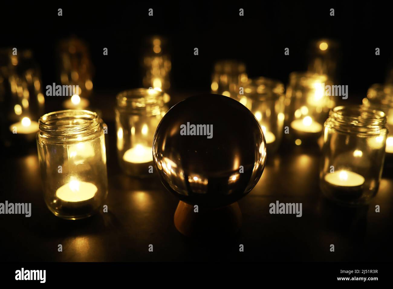 Black background with ball and candles. Divination and prediction of ...