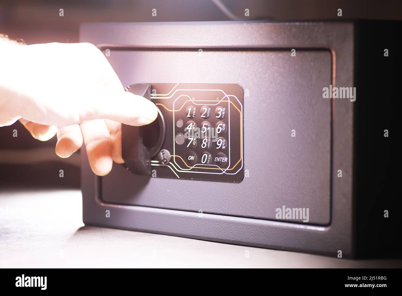 Steel safe with money. Hand putting password in the safety money box in ...