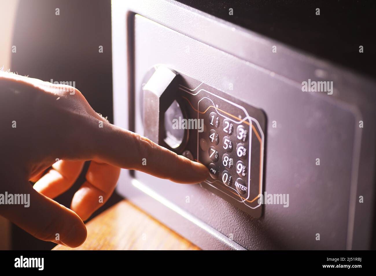 Steel safe with money. Hand putting password in the safety money box in ...
