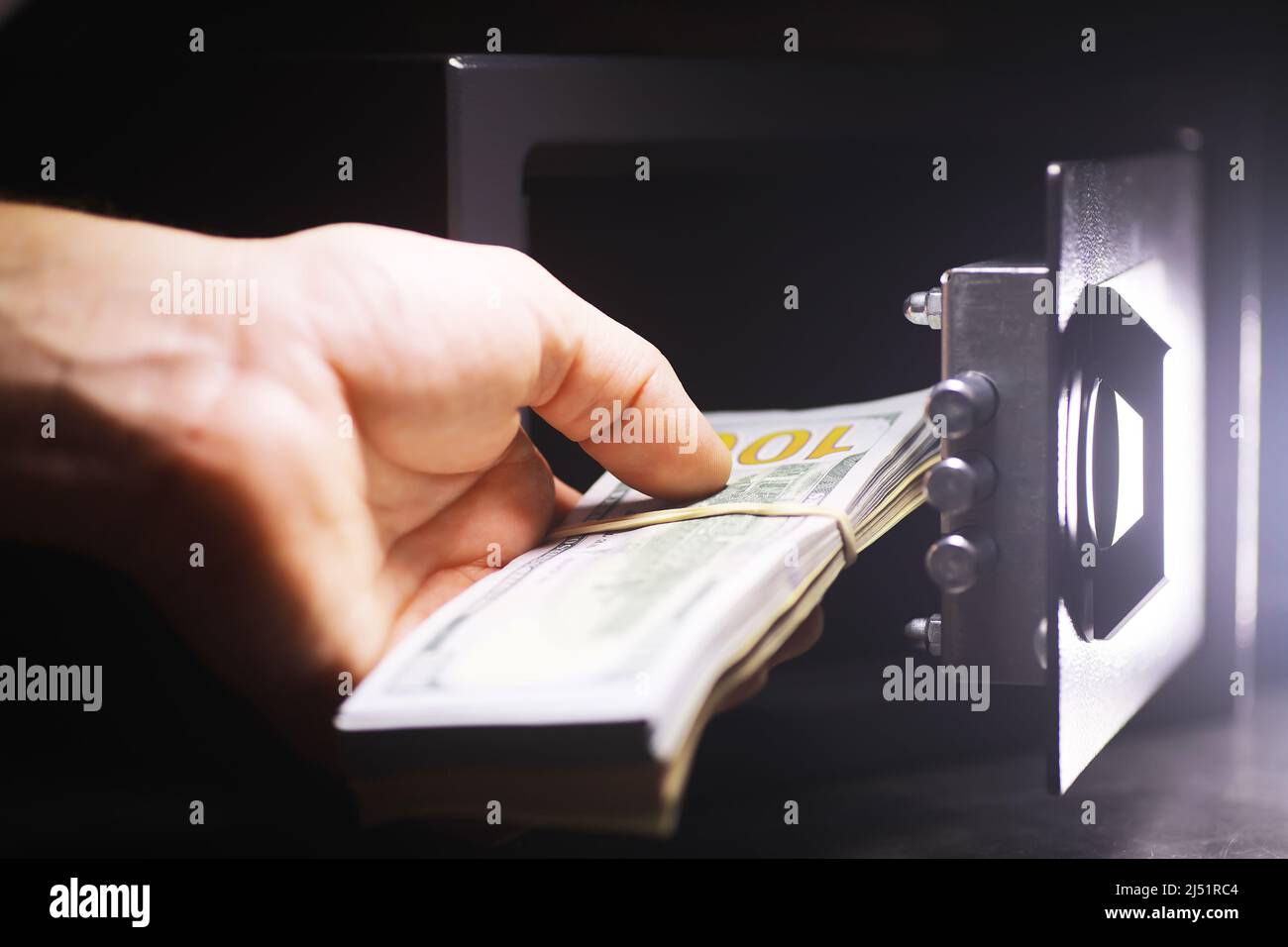 Steel safe with money. Hand putting password in the safety money box in ...