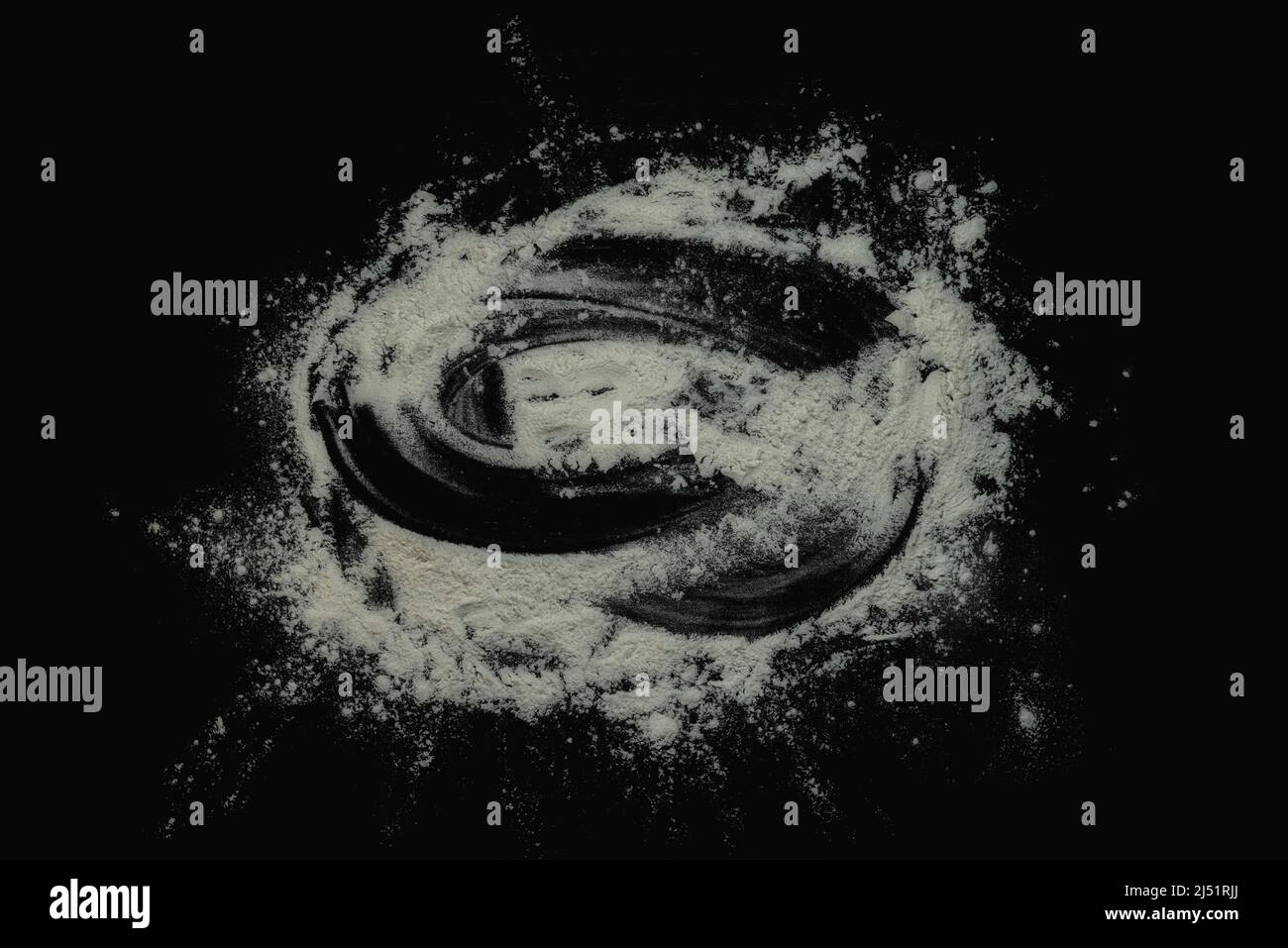 Black background sprinkled with flour, smeared flour, table for cooking ...