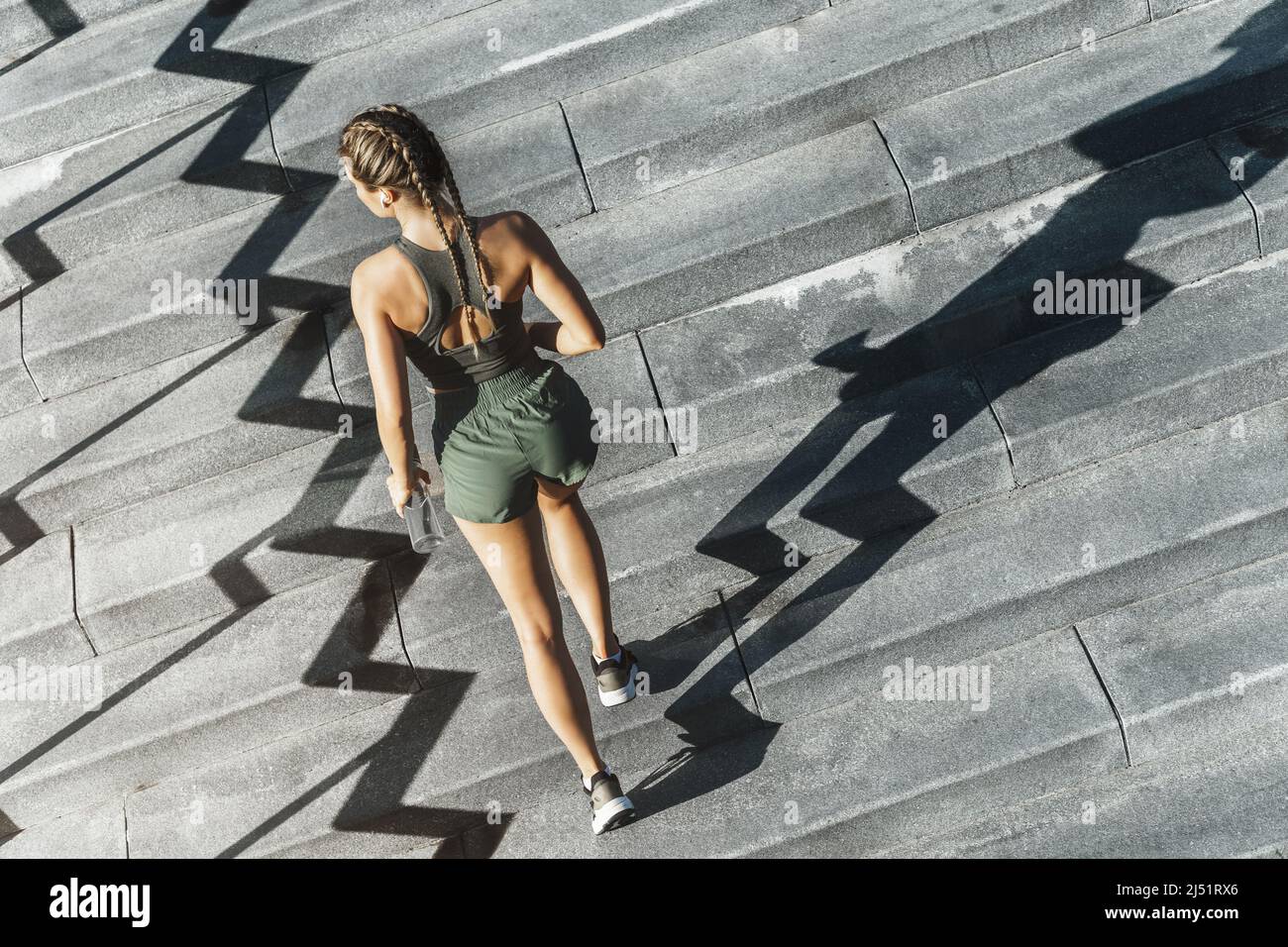 Young sportive woman is running upstairs by a concrete staircase Stock ...