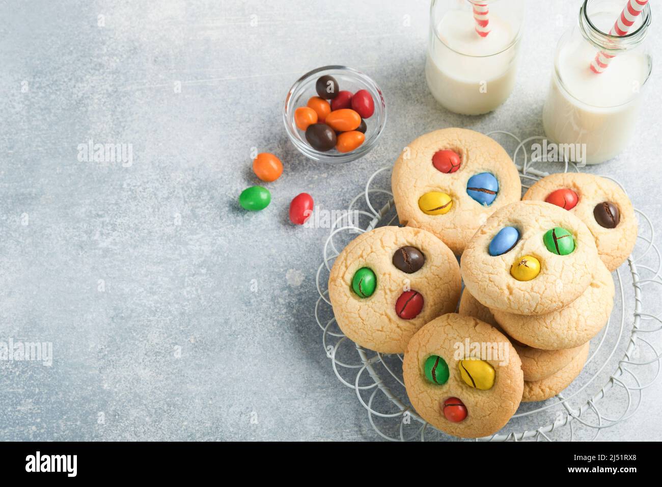 Homemade cookies with colorful chocolate candies and milk. Stack of ...