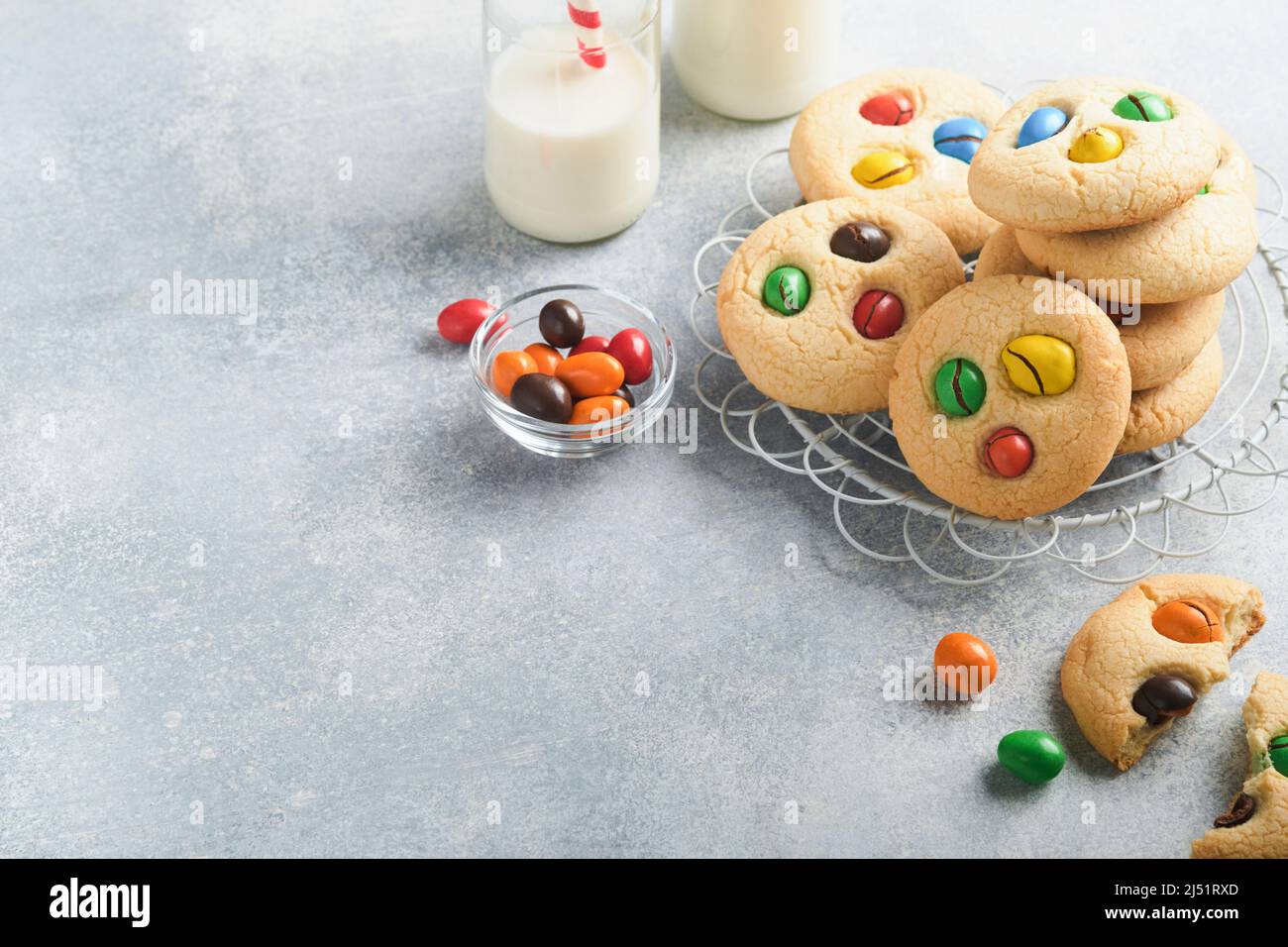 Homemade cookies with colorful chocolate candies and milk. Stack of ...