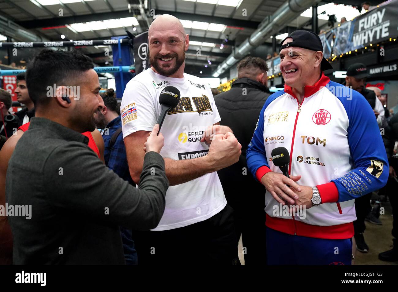 Tyson Fury (centre) and father John Fury (right) being interviewed by ...