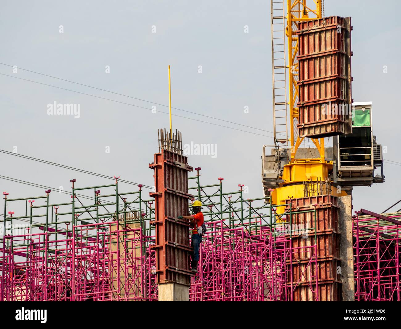 The pink scaffolding on the building under construction Stock Photo - Alamy