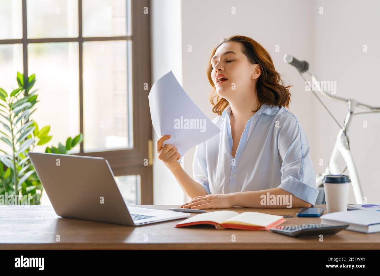 Happy woman ix relaxing working in the office Stock Photo - Alamy