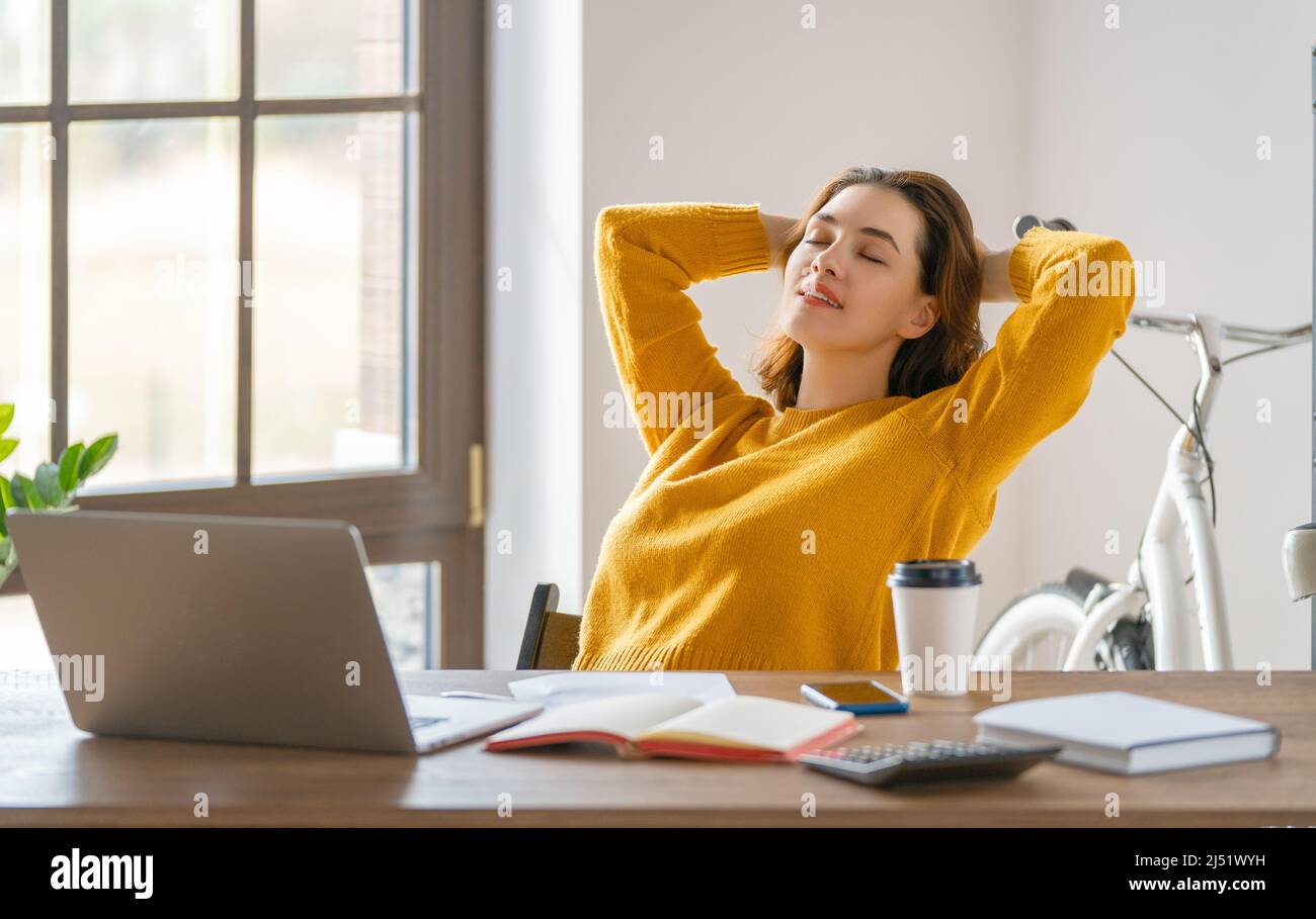 Happy woman ix relaxing working in the office Stock Photo - Alamy