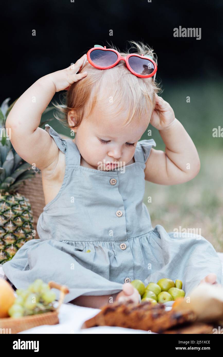 Candid lifestyle portrait of caucasian baby girl one year old eating ...