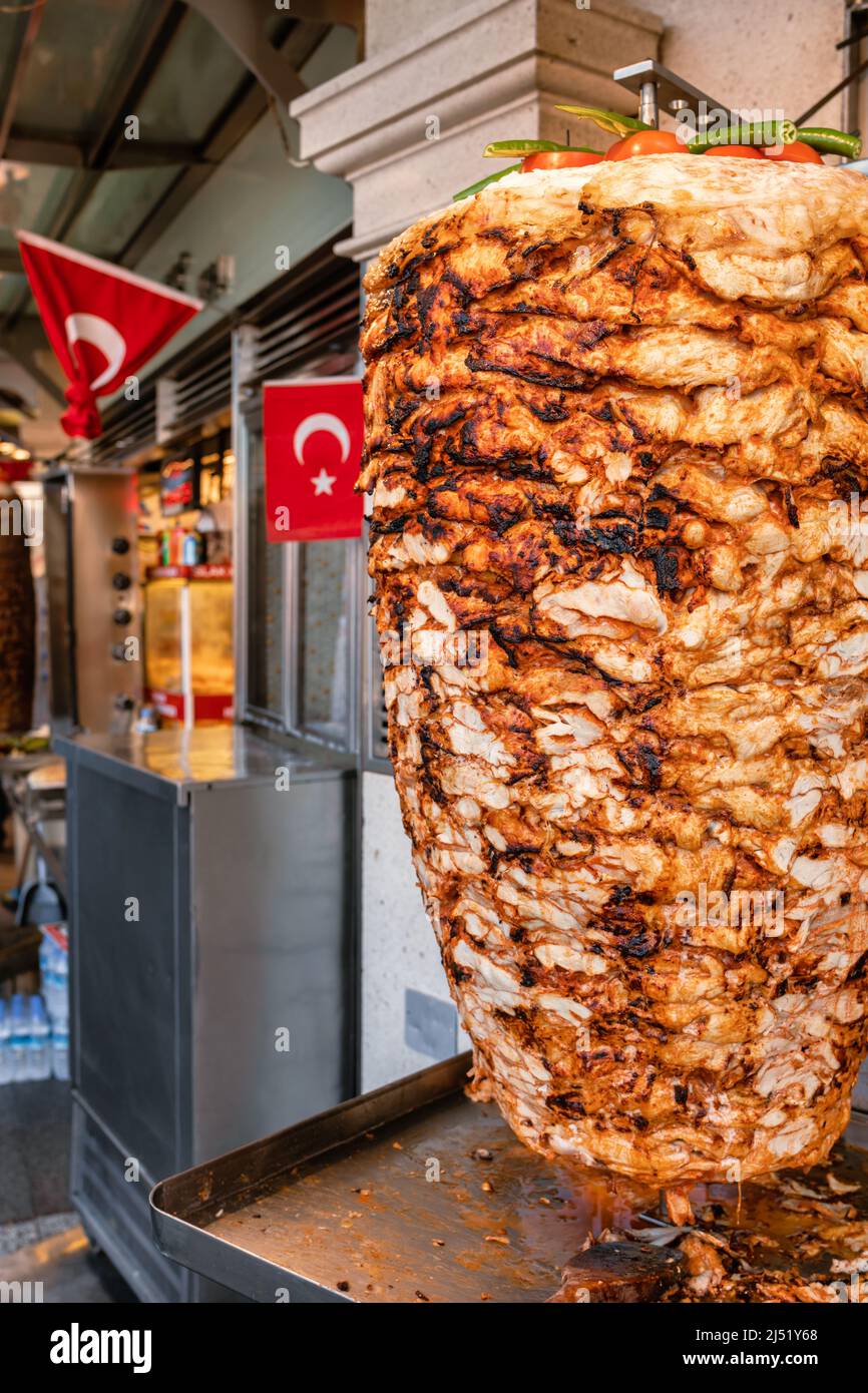 Grilled chicken meat on a vertical rotisserie used in traditional ...
